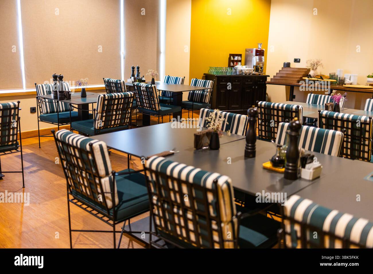 Cozy breakfast room with striped chairs and buffet corner. Modern ...
