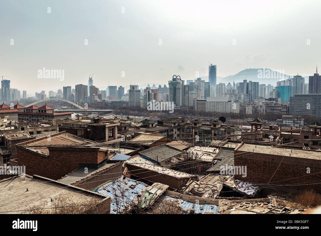 Poor part of chinese city with developed buildings in the background ...