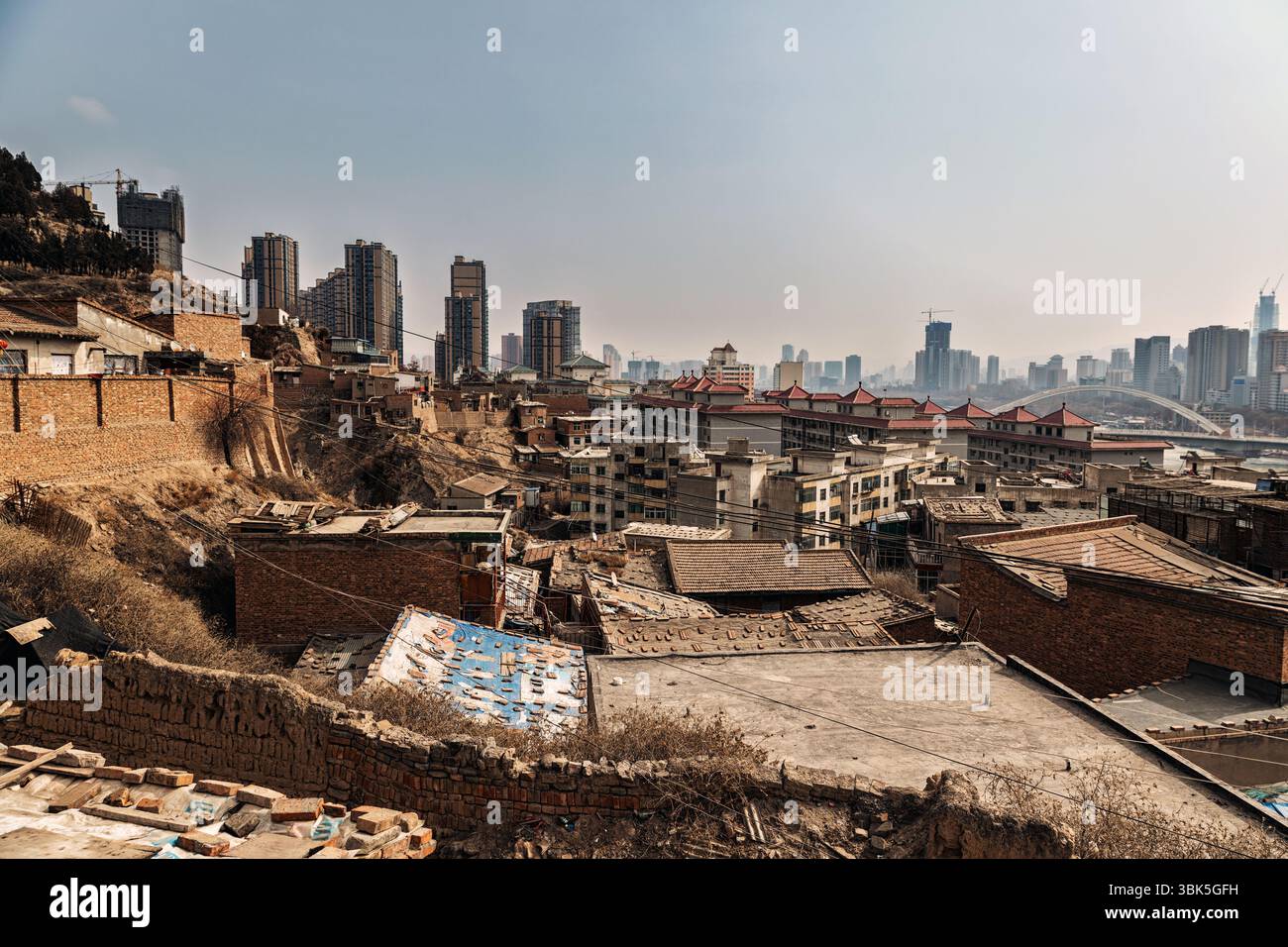 Poor part of chinese city with developed buildings in the background ...