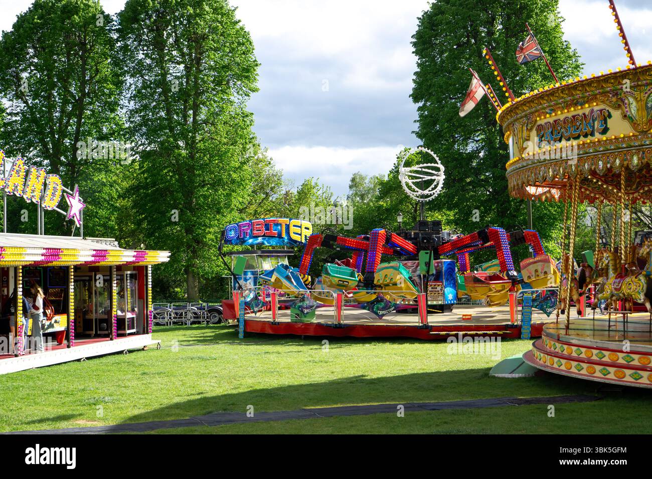 A lively funfair scene in Saffron Walden, England, featuring rides like ...