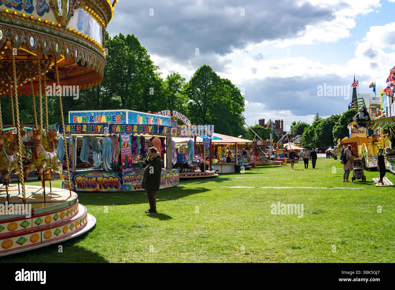 A funfair in Saffron Walden, Essex, UK, with rides and games on a ...