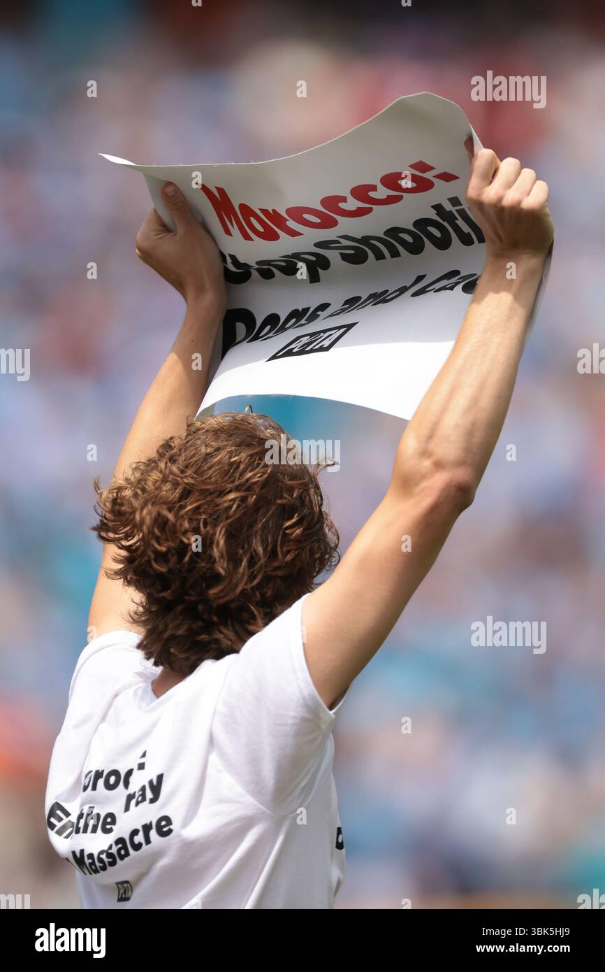Philadelphia, USA, 18th June 2025. A pitch invader displays a banner ...