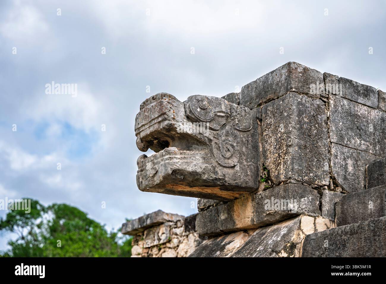 Ancient Maya feathered serpent head sculpture with carved details and ...