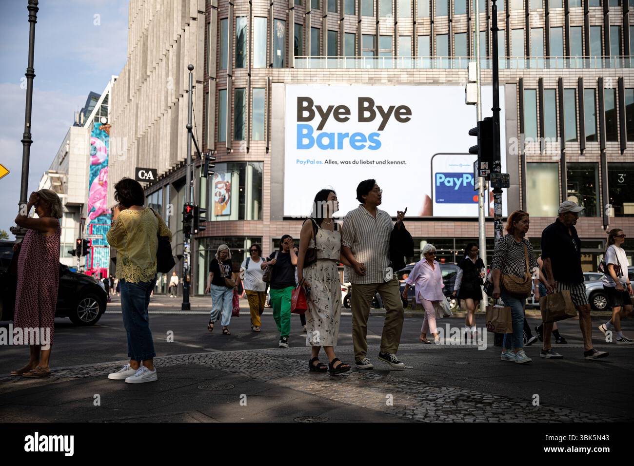 Pedestrians, shoppers, and tourists filled the streets of Berlin's ...