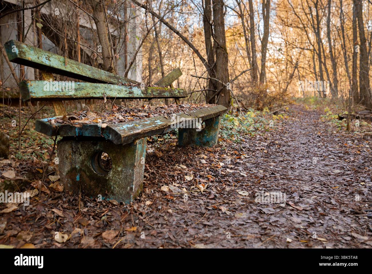 Old destroyed bench next to path angle shot Stock Photo - Alamy