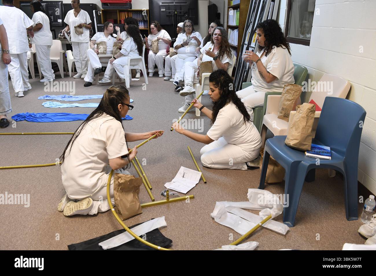 Women in a Texas prison prepare for a graduation ceremony from a multi ...