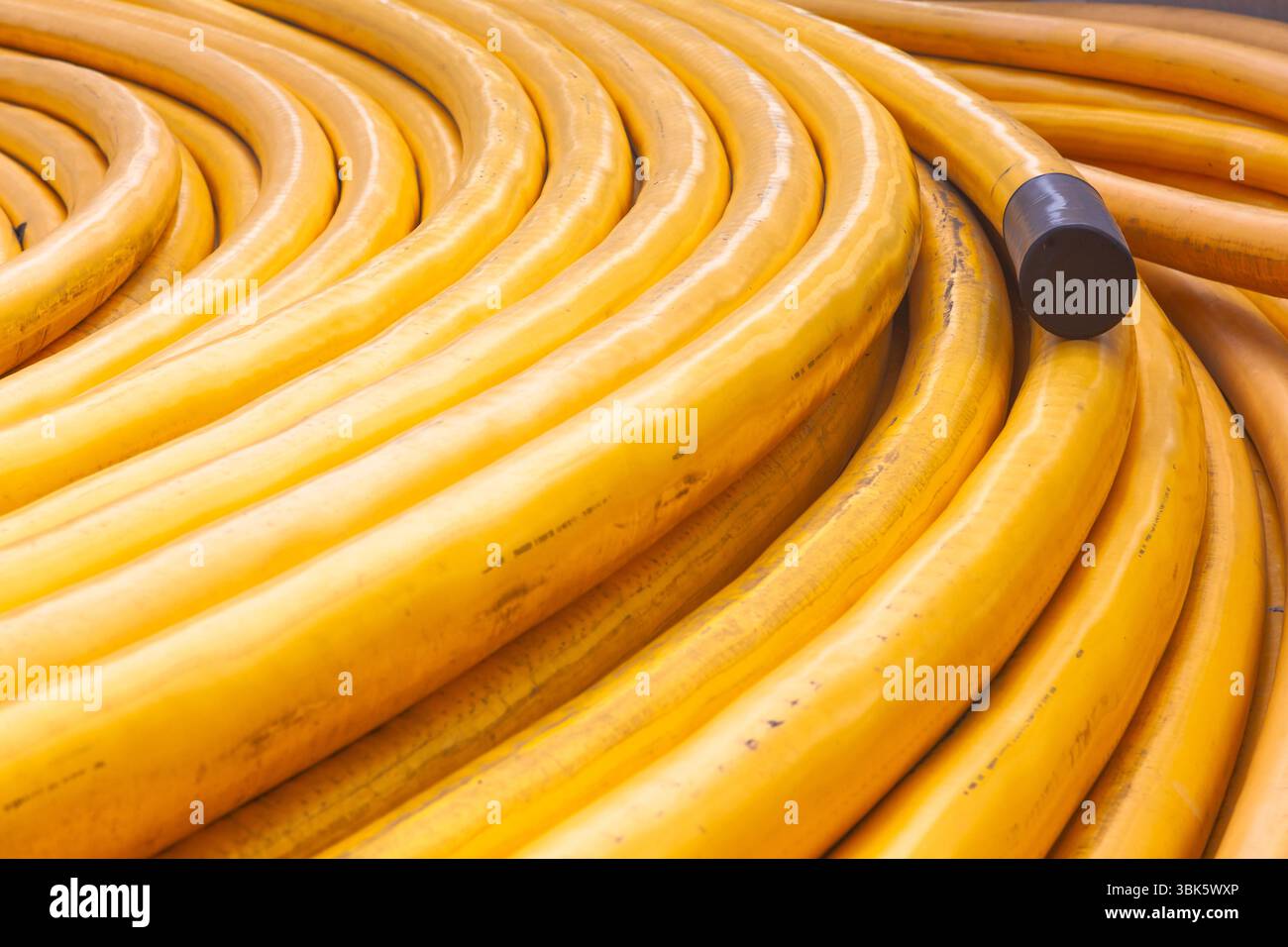 New powerful high-voltage cable in yellow braiding twisted on the ...