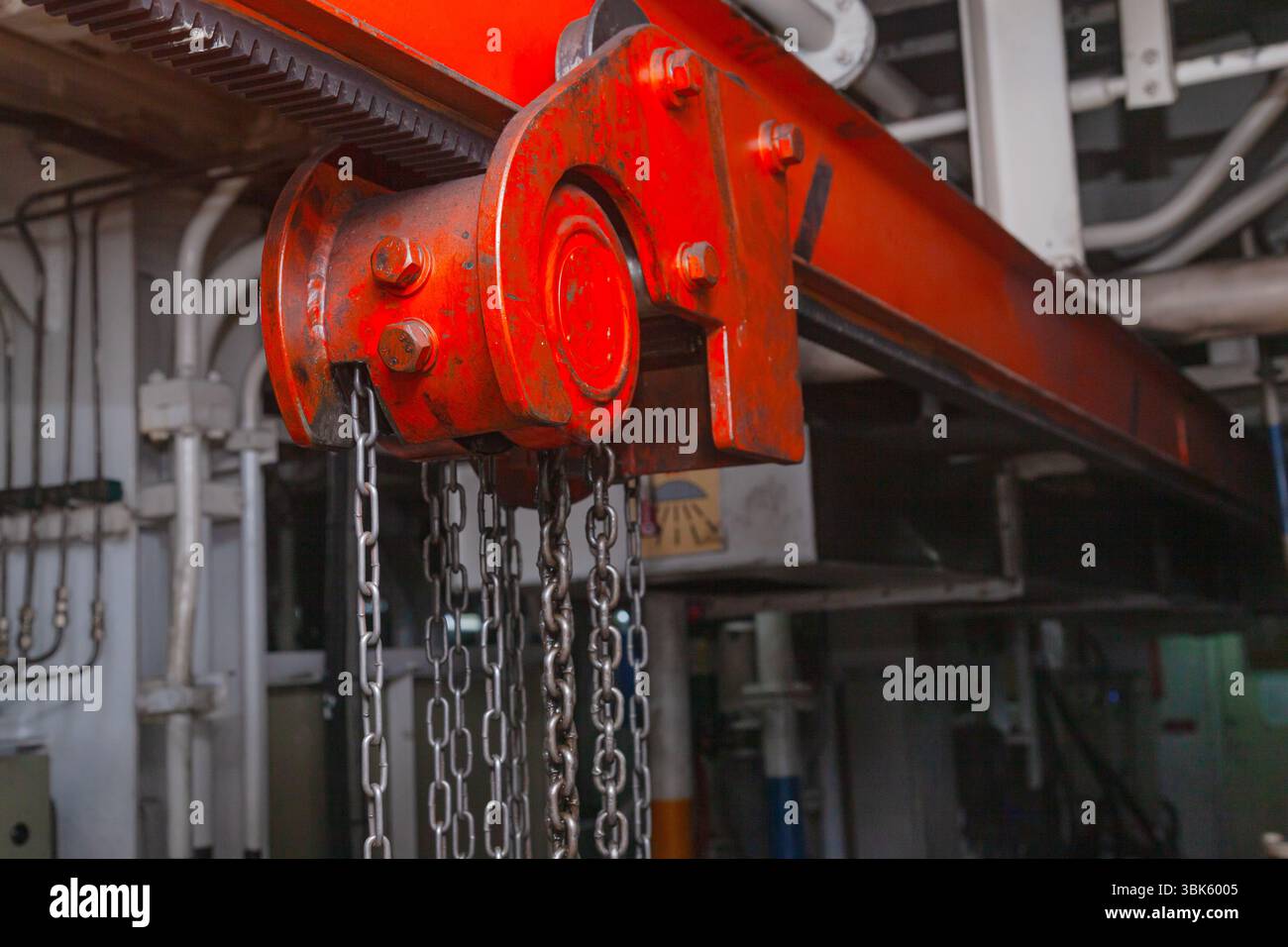 A chain hoist on a beam in the engine room of a ship Stock Photo - Alamy