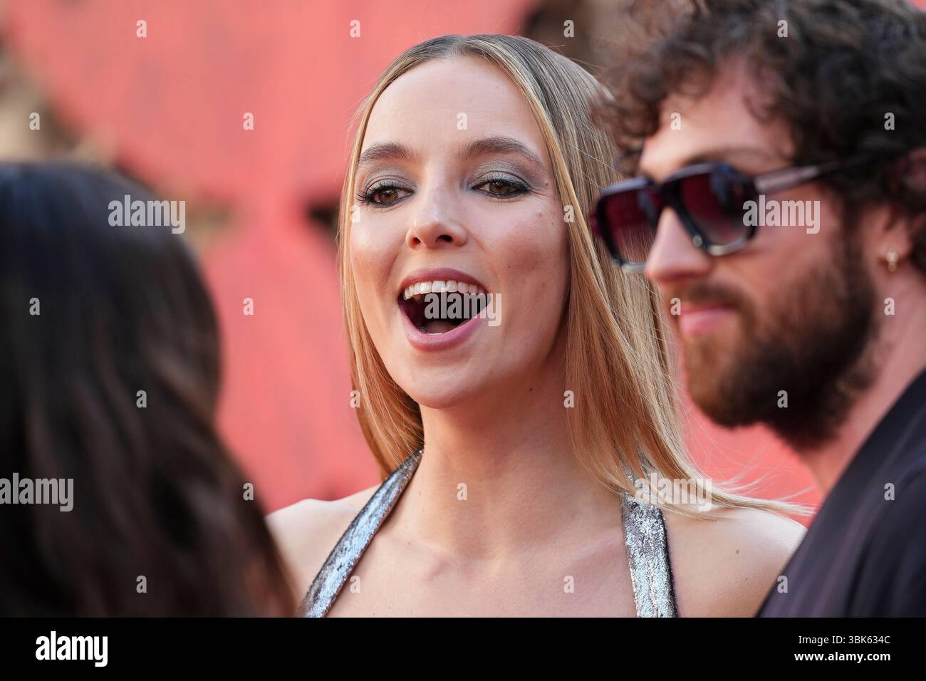 Jodie Comer, centre, reacts alongside Aaron Taylor-Johnson, right, upon ...