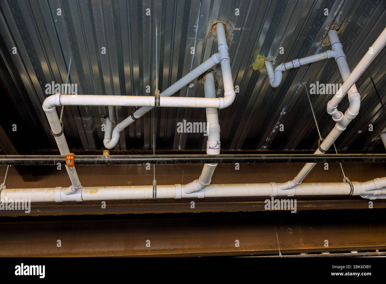 Pipes are installed on ceiling of commercial building to manage ...