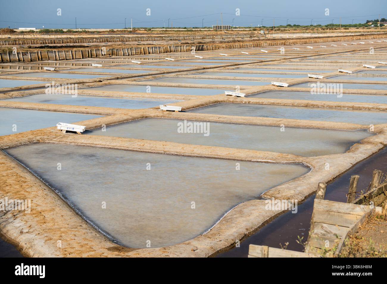 Rows of shallow evaporation ponds form a geometric pattern in a salt ...