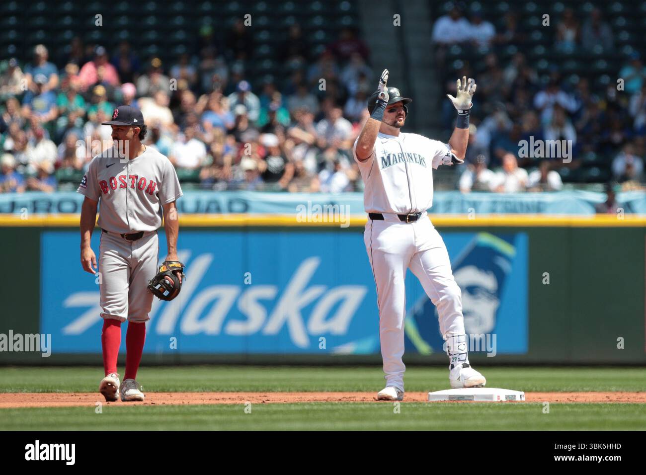Seattle Mariners' Cal Raleigh, right, celebrates after hitting a double ...