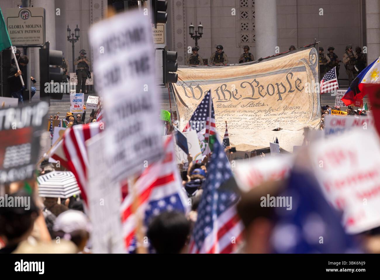 Los Angeles, California, USA - June 14, 2025: People hold the ...