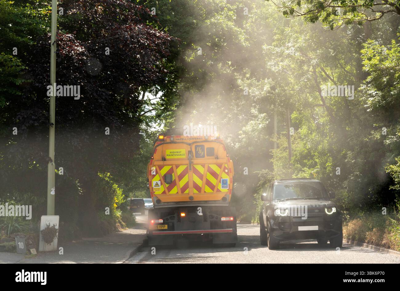 North West England UK. 02.06.2025. Road sweeping vehicle creating a ...