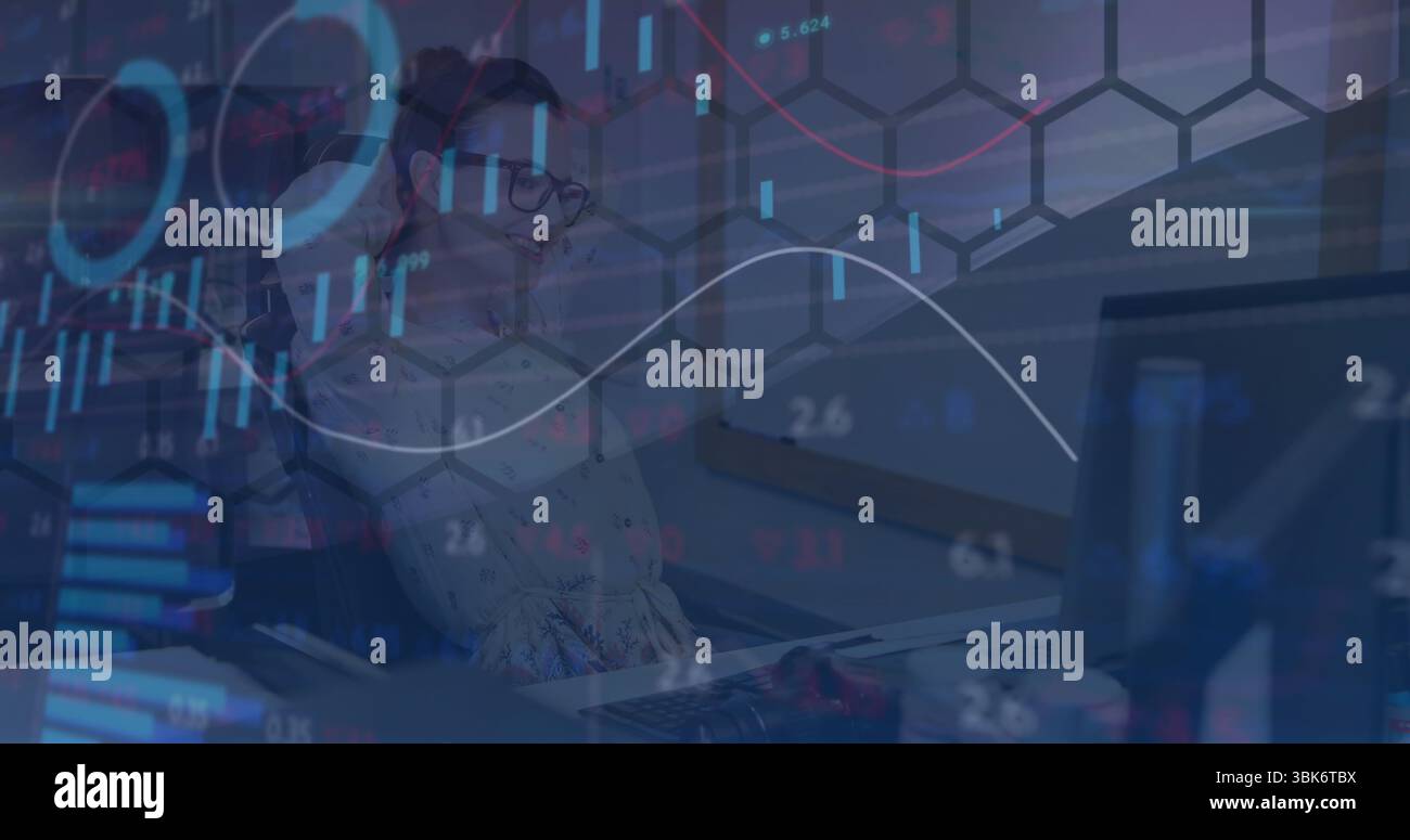 Leaning analyst examining data charts on computer monitor at office desk, with keyboard and ...