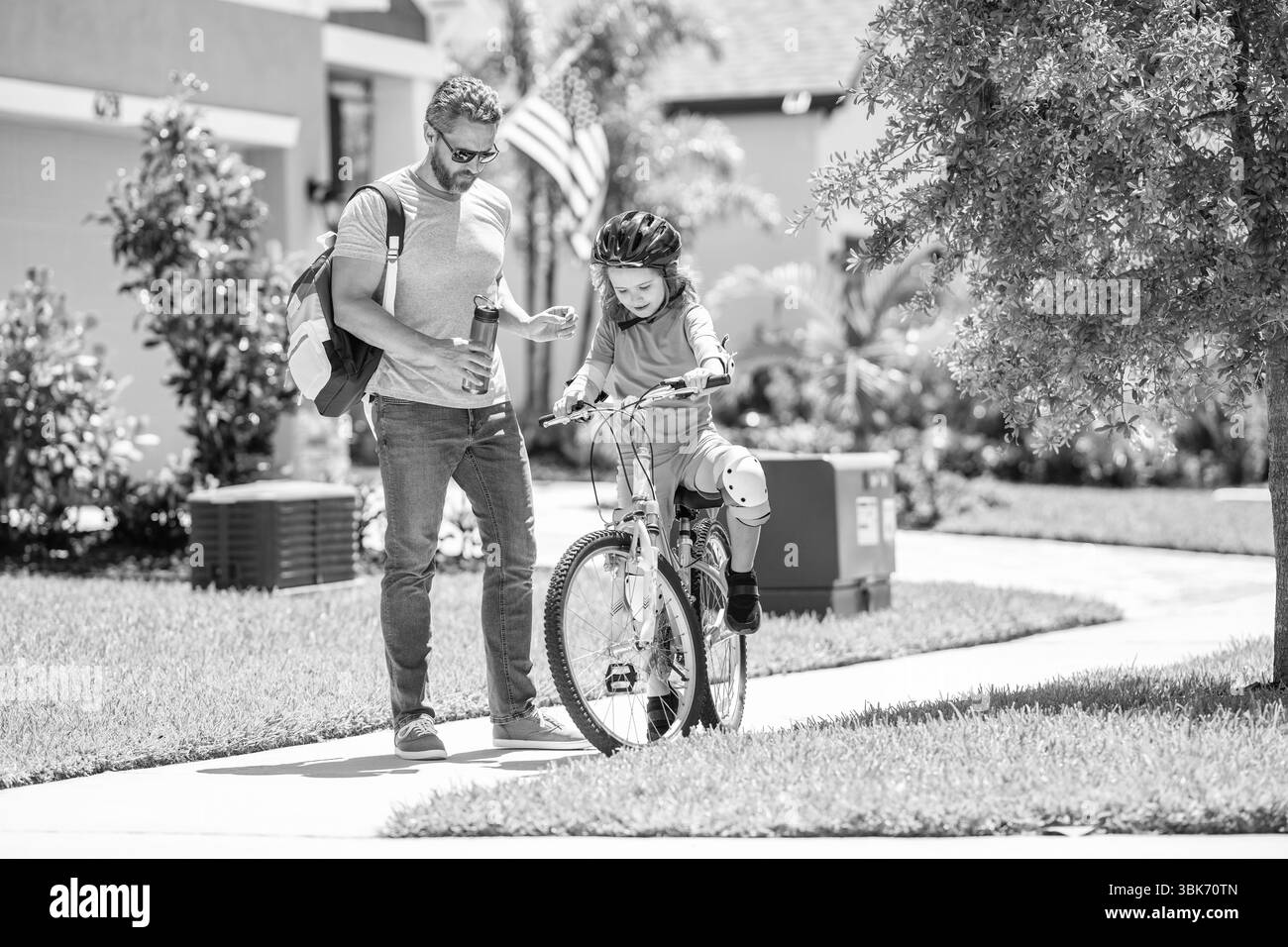 father and son enjoying a bicycle ride together. active son and father ...