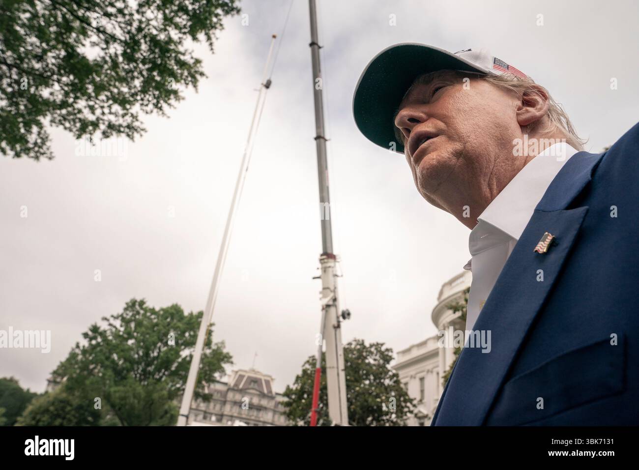 United States President Donald J Trump looks back at workers as they ...