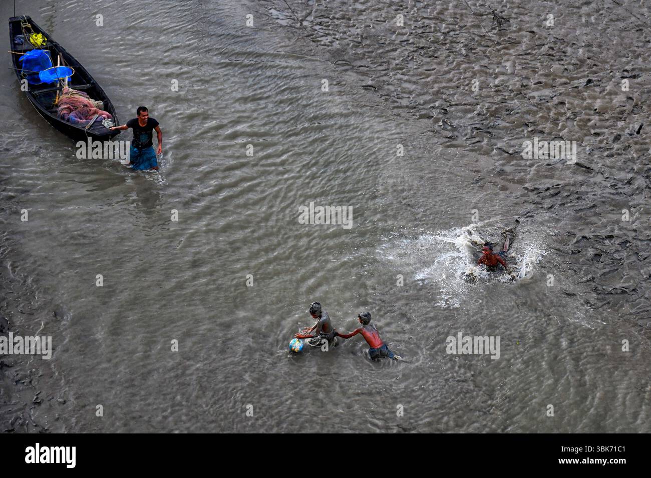 Children seen playing football after fishing on the Matla river. In the ...