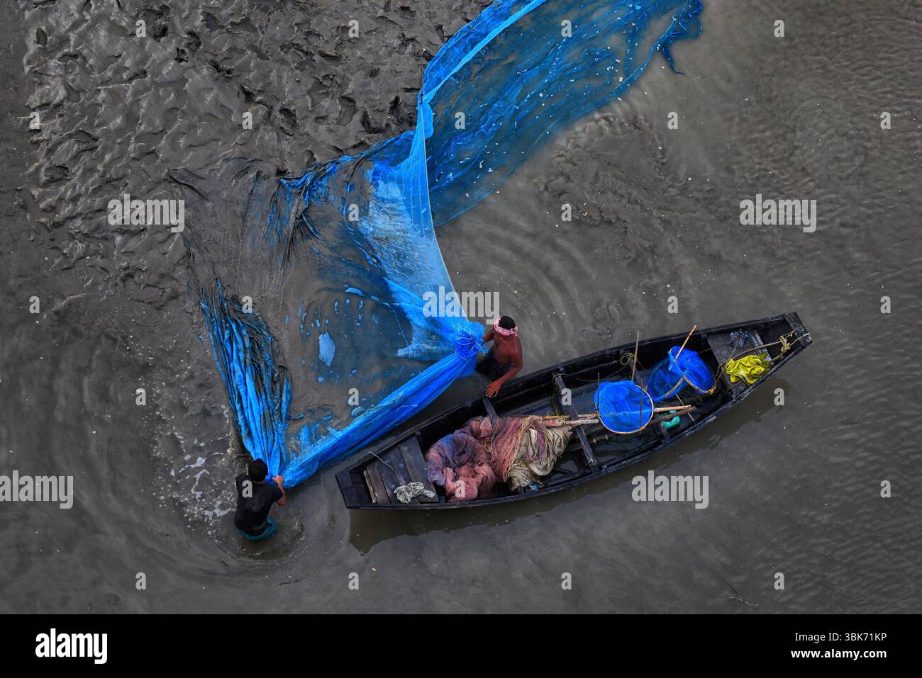 Fishermen seen winding up their fishing nets after completion of the ...