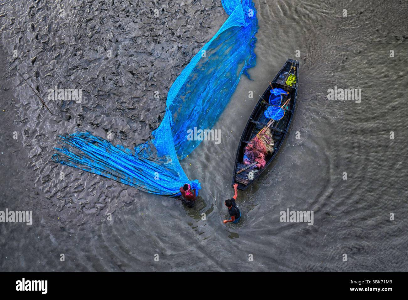 Fishermen seen winding up their fishing nets after completion of their ...