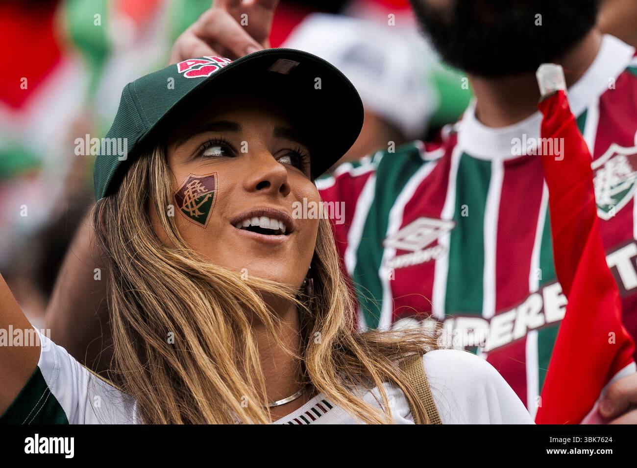 A fan of Fluminense FC with the crest of Fluminense FC painted on her ...