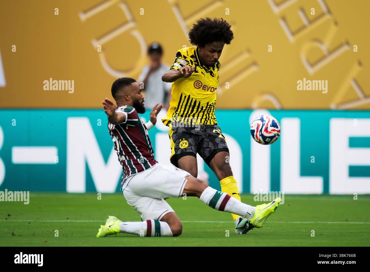 Karim Adeyemi of Borussia Dortmund competes for the ball with Samuel ...