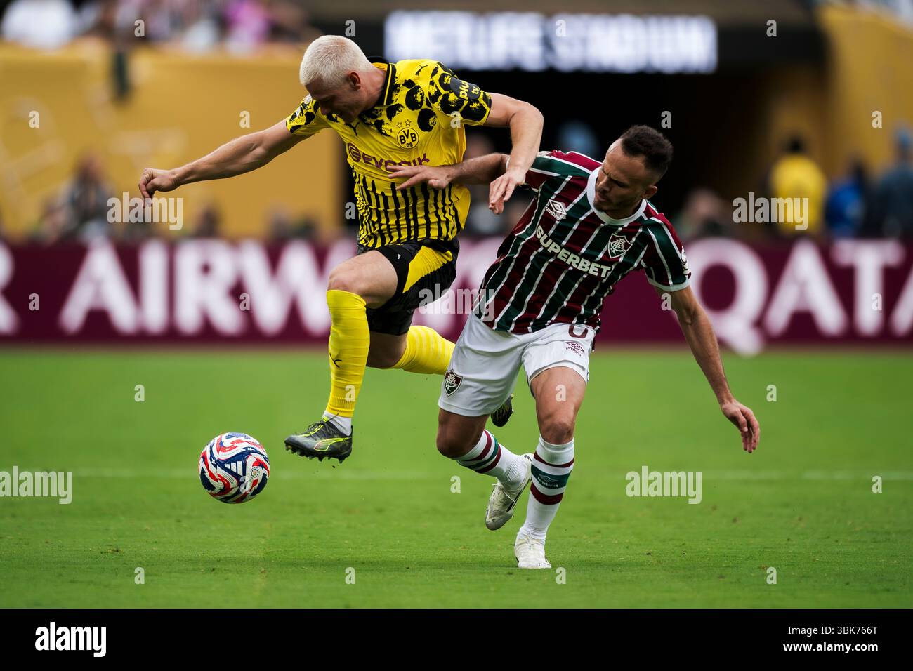 Julian Ryerson of Borussia Dortmund competes for the ball with Rene of ...