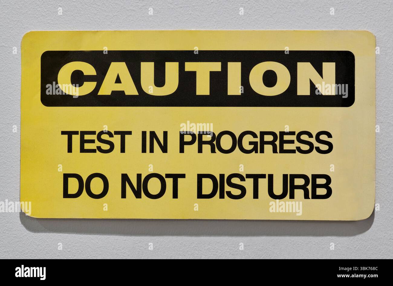 Caution test in progress do not disturb sign notice on wall industrial ...