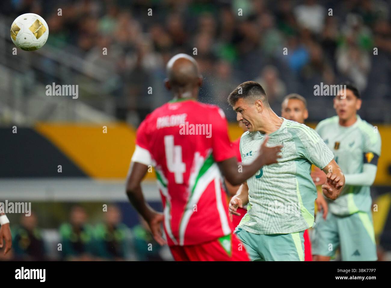Mexico defender César Montes, right, heads in a goal against Suriname ...