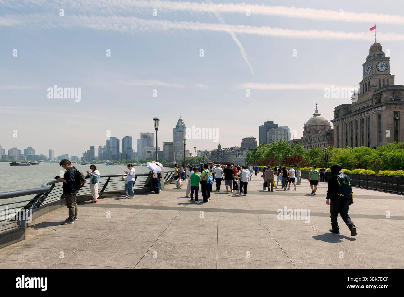 Shanghai, China - April 20, 2025: Pedestrians strolling along the Bund ...