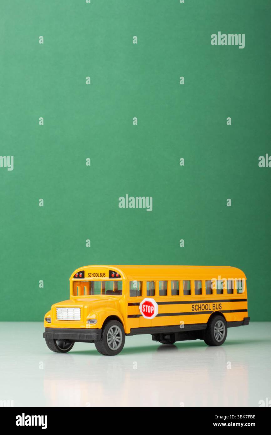 Yellow School Bus Toy with Green Background, back to school concept ...