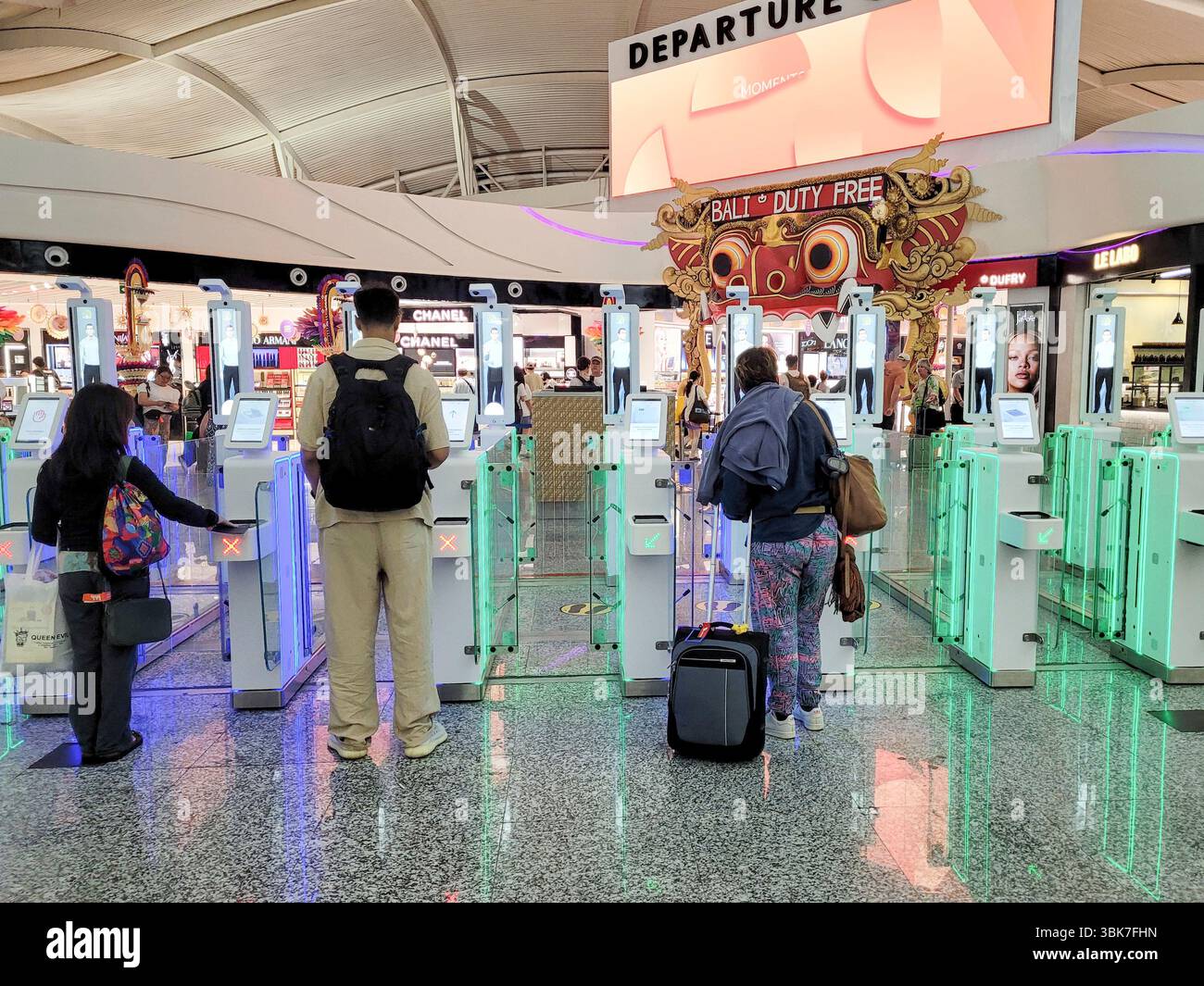 Air travellers going through automated passport control gates at Bali ...