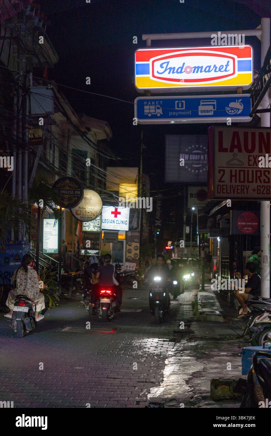 Bali, Indonesia - Dec 25, 2024: Man sits on the sidewalk in front of ...