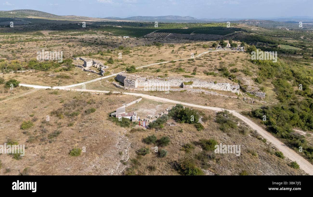 Aerial view of ancient ruins of Asseria on a hill surrounded by a vast ...
