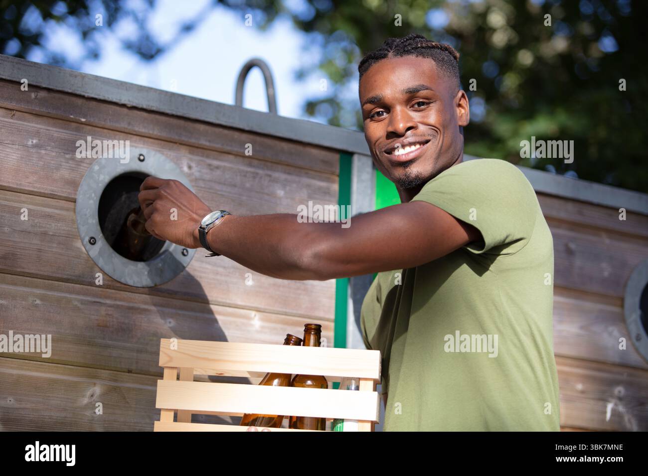 Man recycling glass bottles hi-res stock photography and images - Alamy