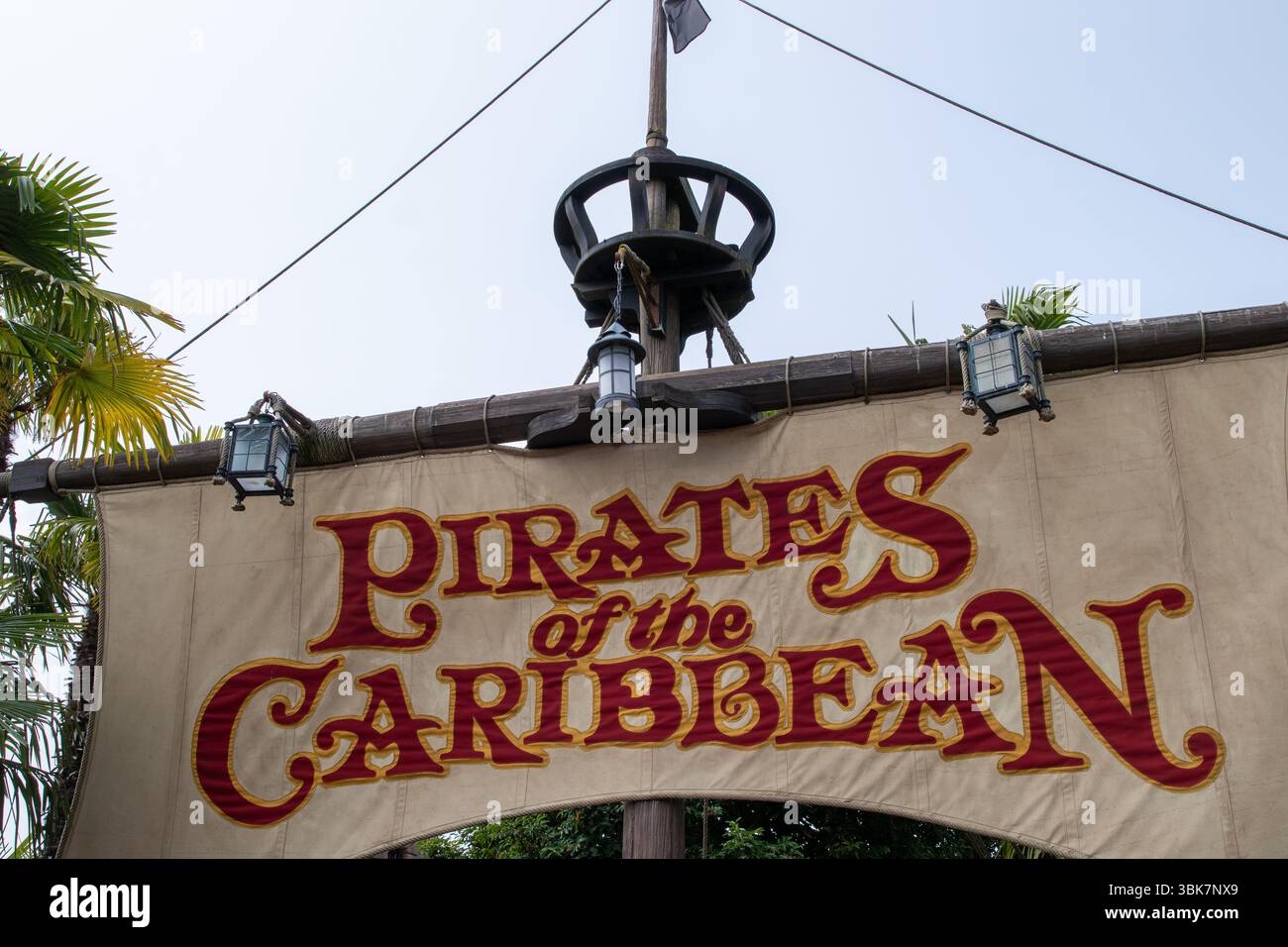 A sign for "Pirates of the Caribbean" with rope border hangs below a ...