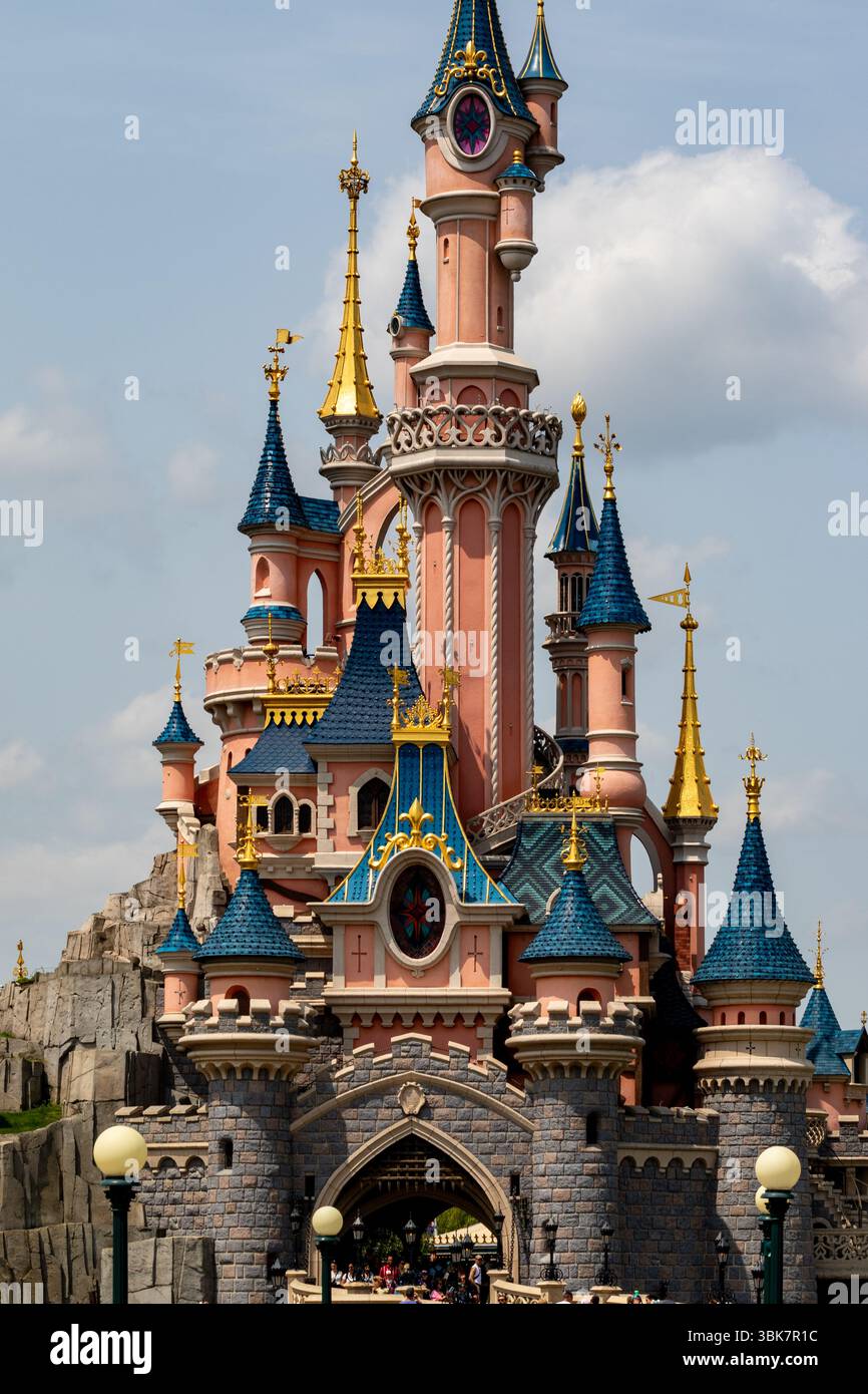 Close-up shot of Sleeping Beauty Castle with pink towers, blue roofs ...