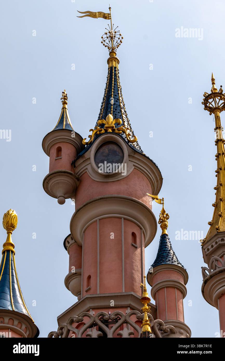 Close-up view of ornate castle turrets with peach walls, dark blue ...