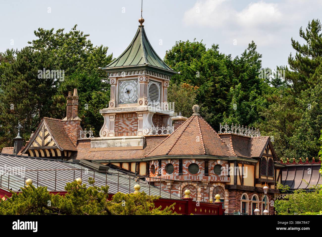 A whimsical architectural building with a clock tower, decorative ...