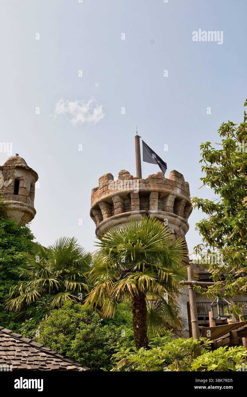 Low-angle shot of two stone towers surrounded by tropical vegetation ...