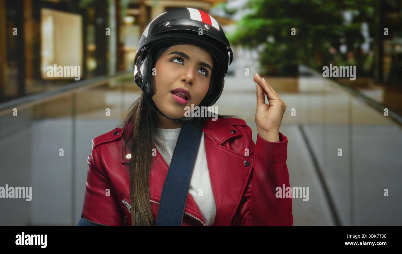 Woman lifts her arm in a subtle gesture on a crowded street by a young ...