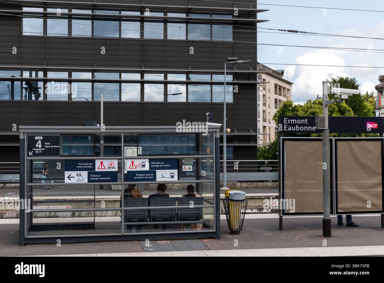 Train station platform with a shelter, information signs, and a modern ...