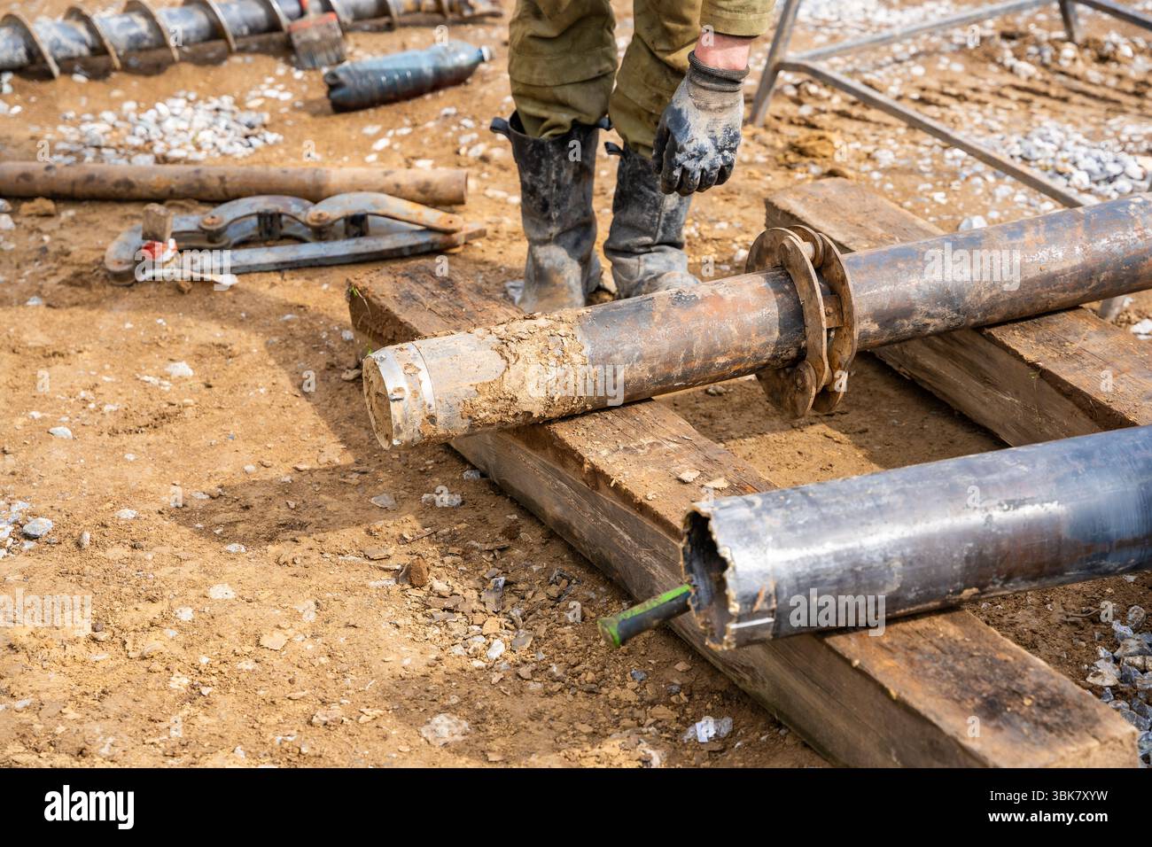 Opening of container with soil sample extracted from borehole ...