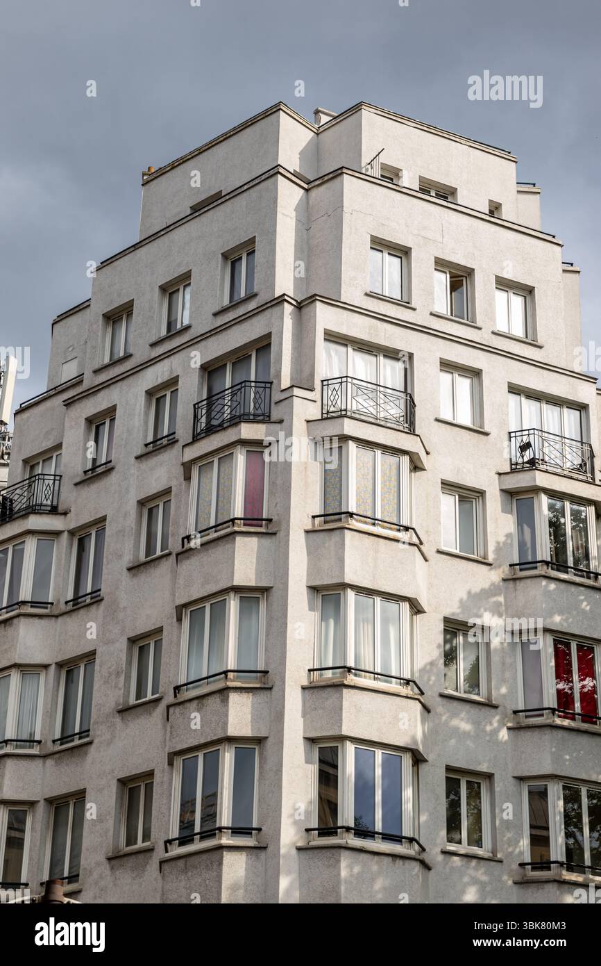 Low-angle view of a multi-story, stepped building with multiple windows ...