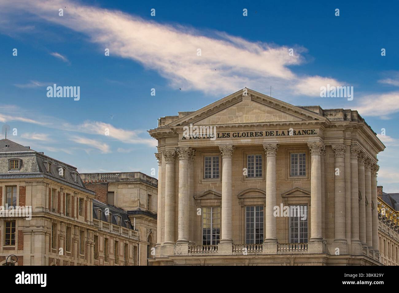 The image features a neoclassical building with columns and a pediment ...