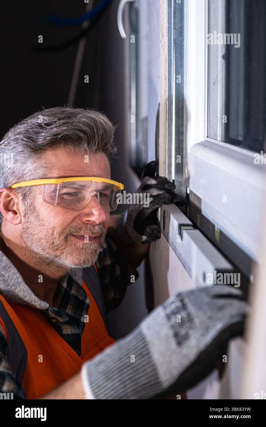 A professional installer checks the horizontal alignment of a newly ...