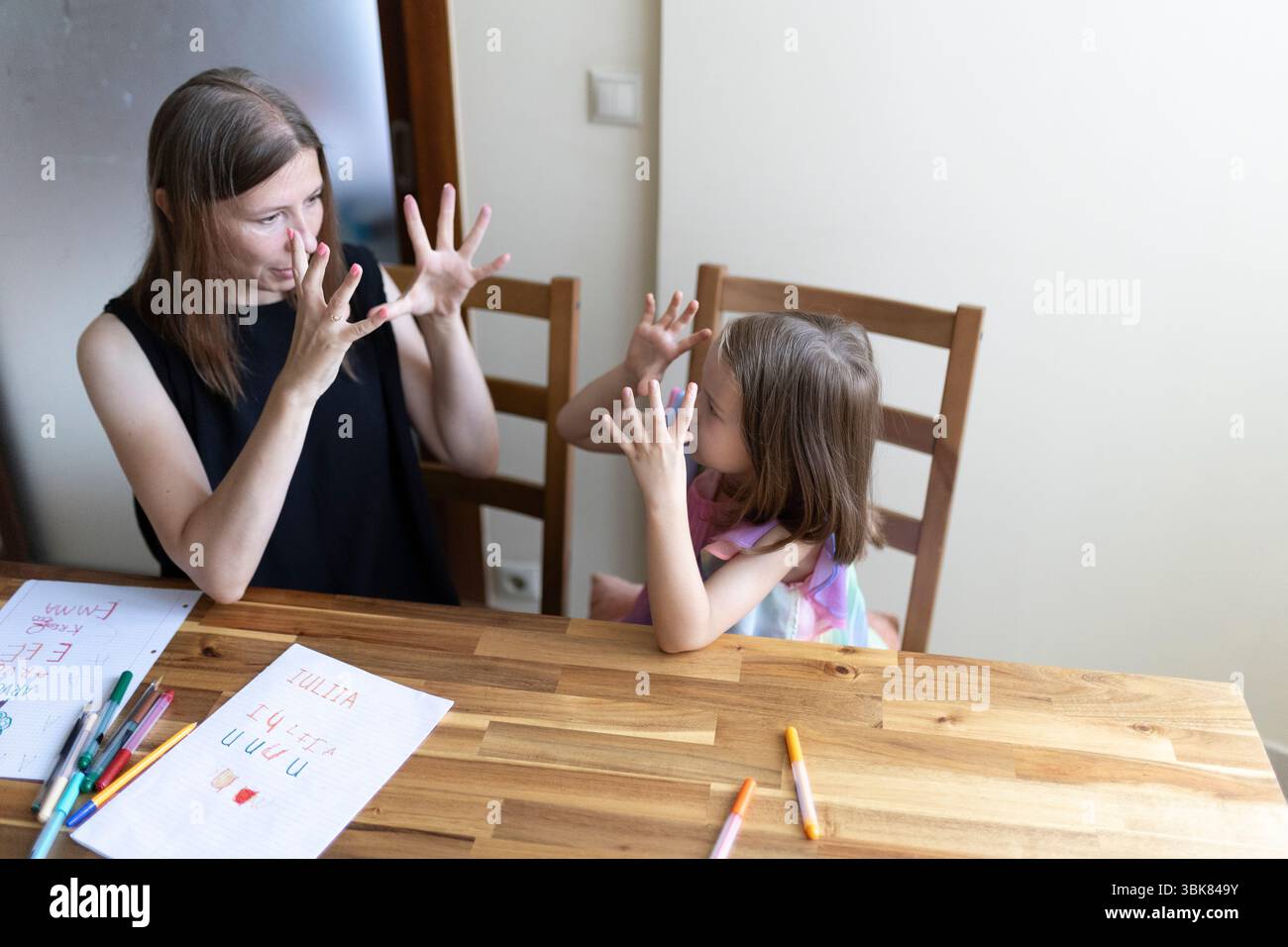 Mother daughter communicating using sign hi-res stock photography and ...