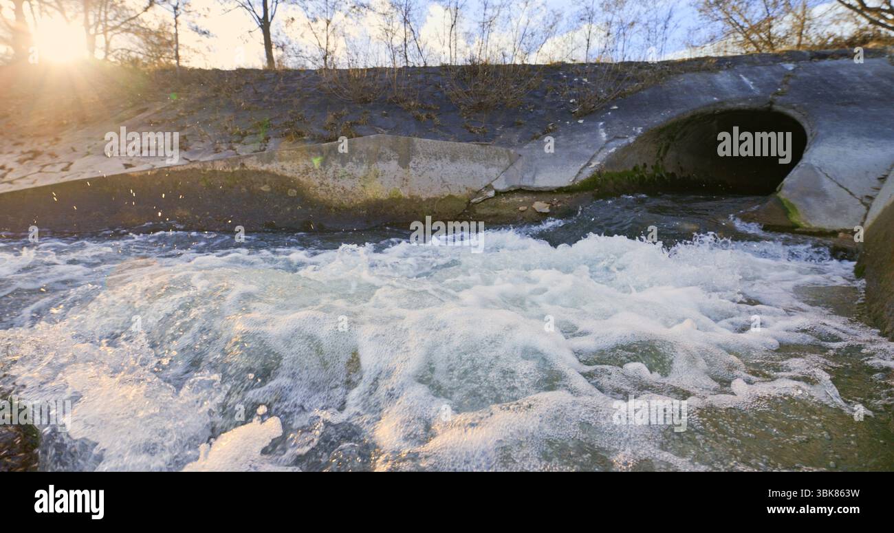 Large sewage tunnel with filth flowing out angle shot Stock Photo - Alamy