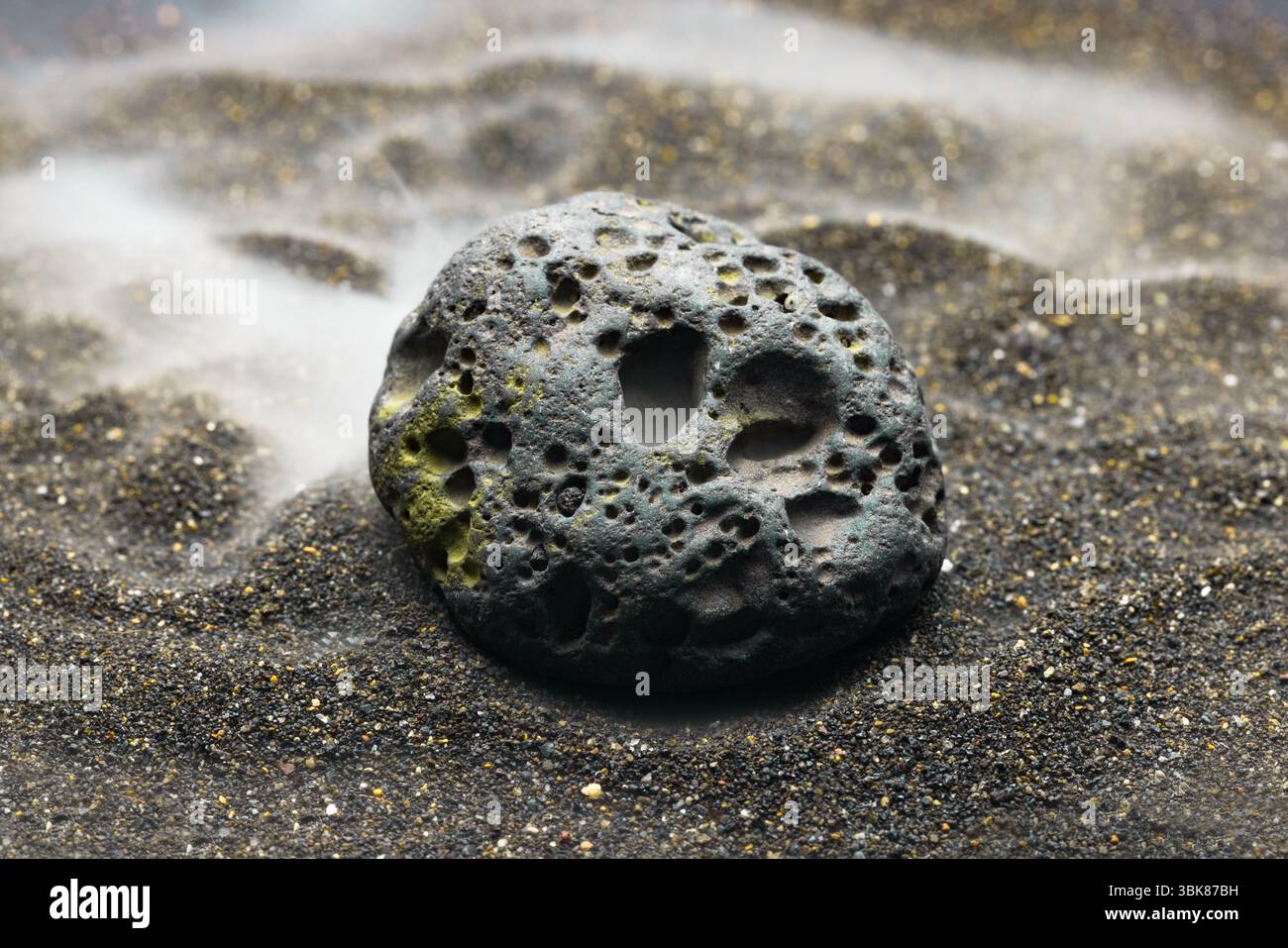 Smoke whirling around small meteorite stone closeup footage Stock Photo ...