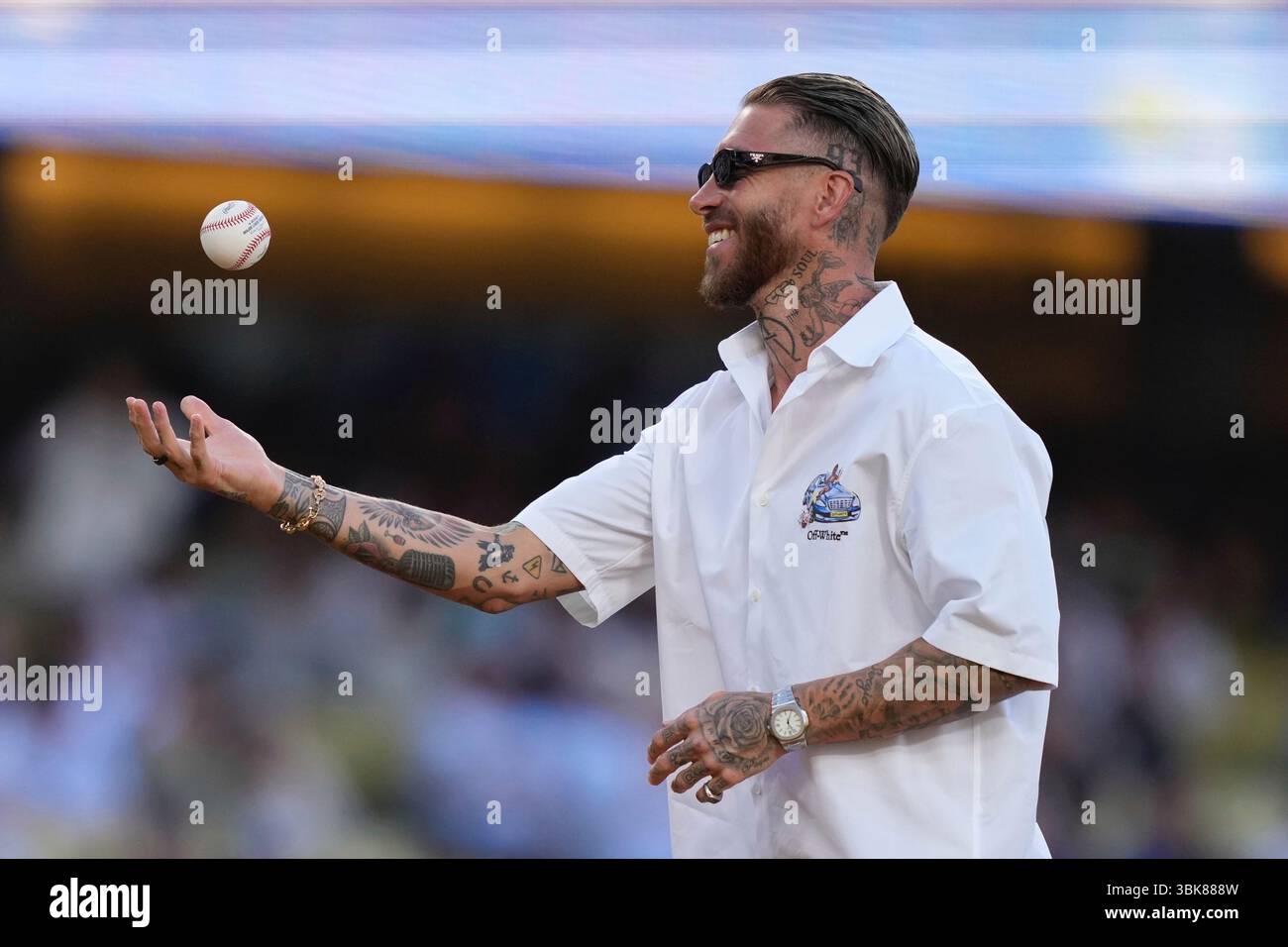 Soccer player Sergio Ramos tosses the ball before throwing out the ...
